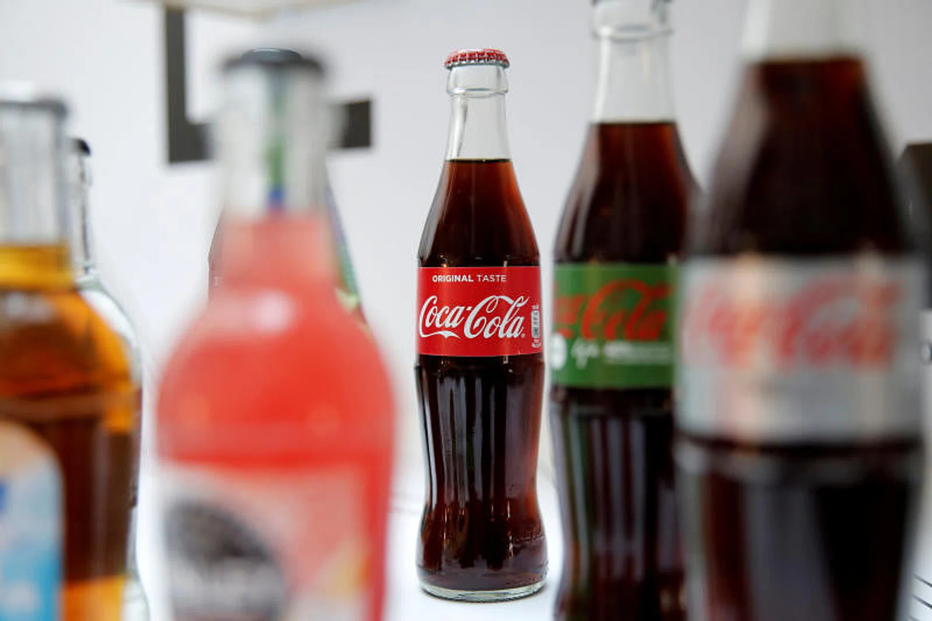 Coca Cola profit drops 60% on refranchising charge - The Business Times